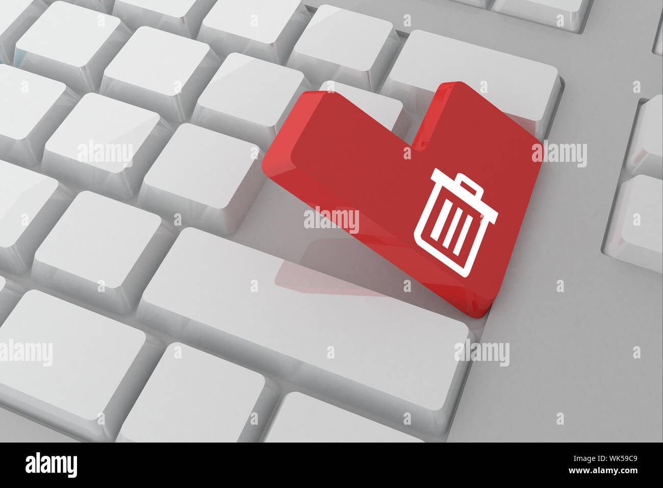 Trash can against white keyboard with red key Stock Photo - Alamy