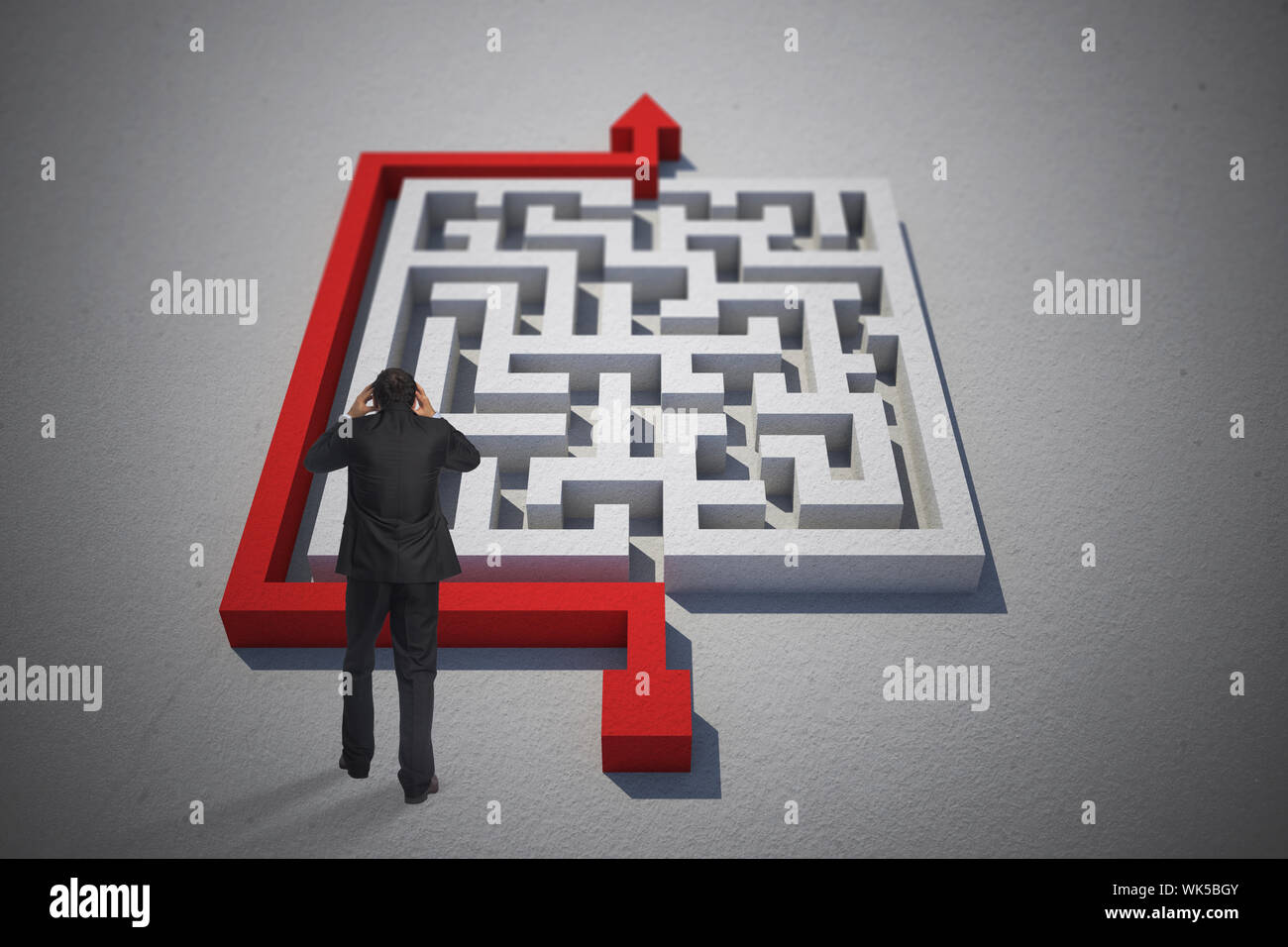 Gesturing businessman against maze with arrow in sky Stock Photo - Alamy