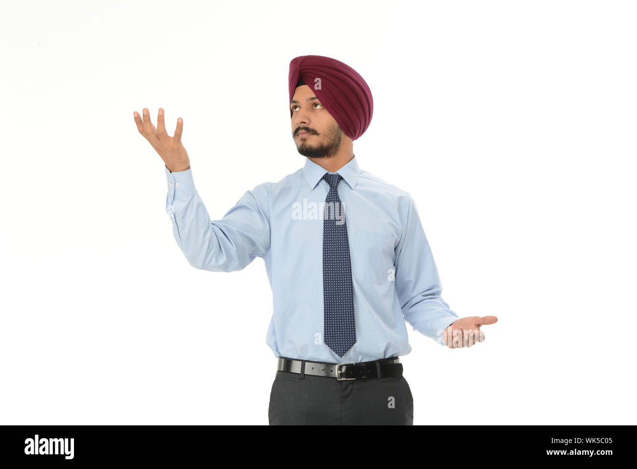 Indian businessman standing with his arm outstretched Stock Photo - Alamy