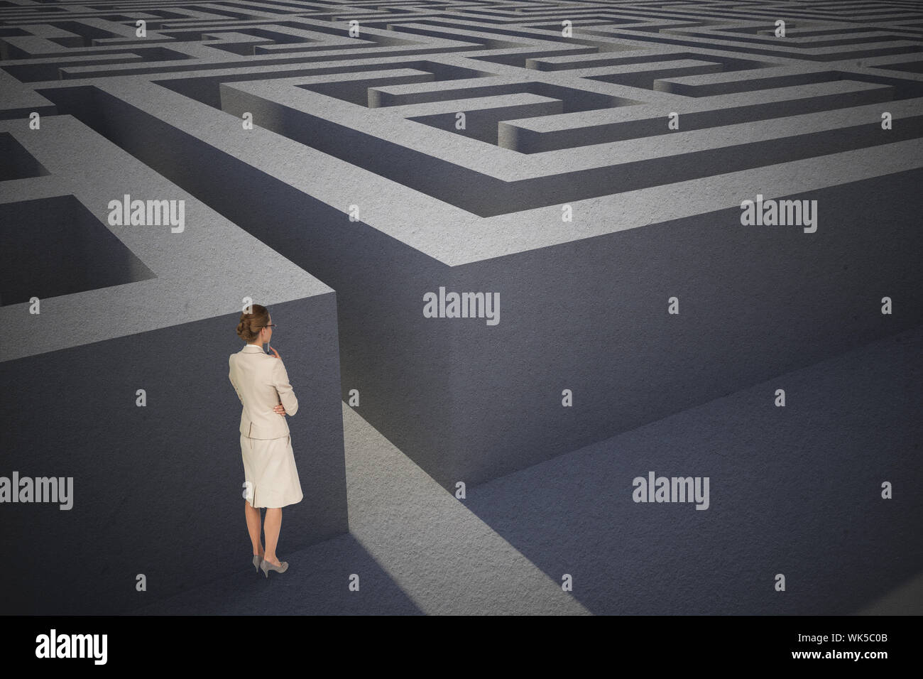 Thinking businesswoman against entrance to difficult maze puzzle Stock ...