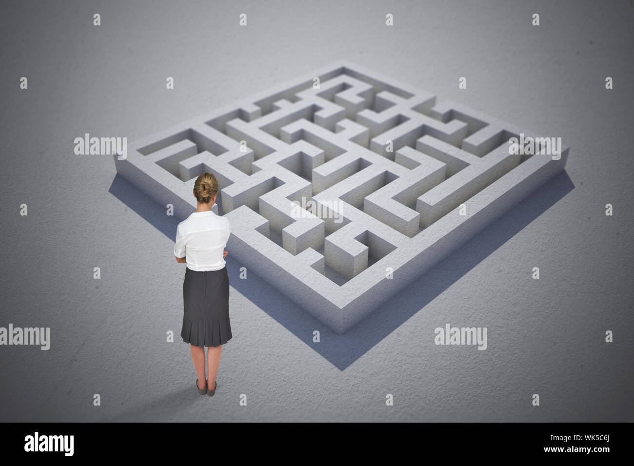 Thinking businesswoman against difficult maze puzzle Stock Photo - Alamy