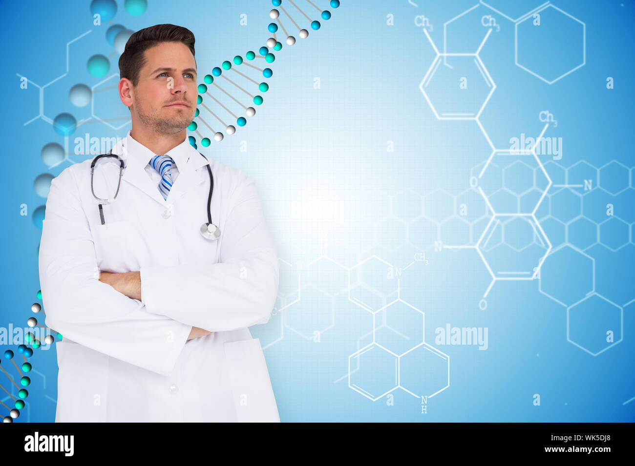 Handsome doctor with arms crossed against dna helix in blue with ...