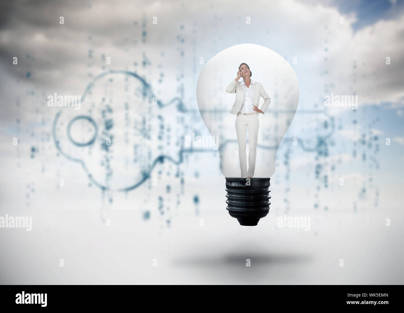 Thinking businesswoman in light bulb against blue key in sky Stock ...