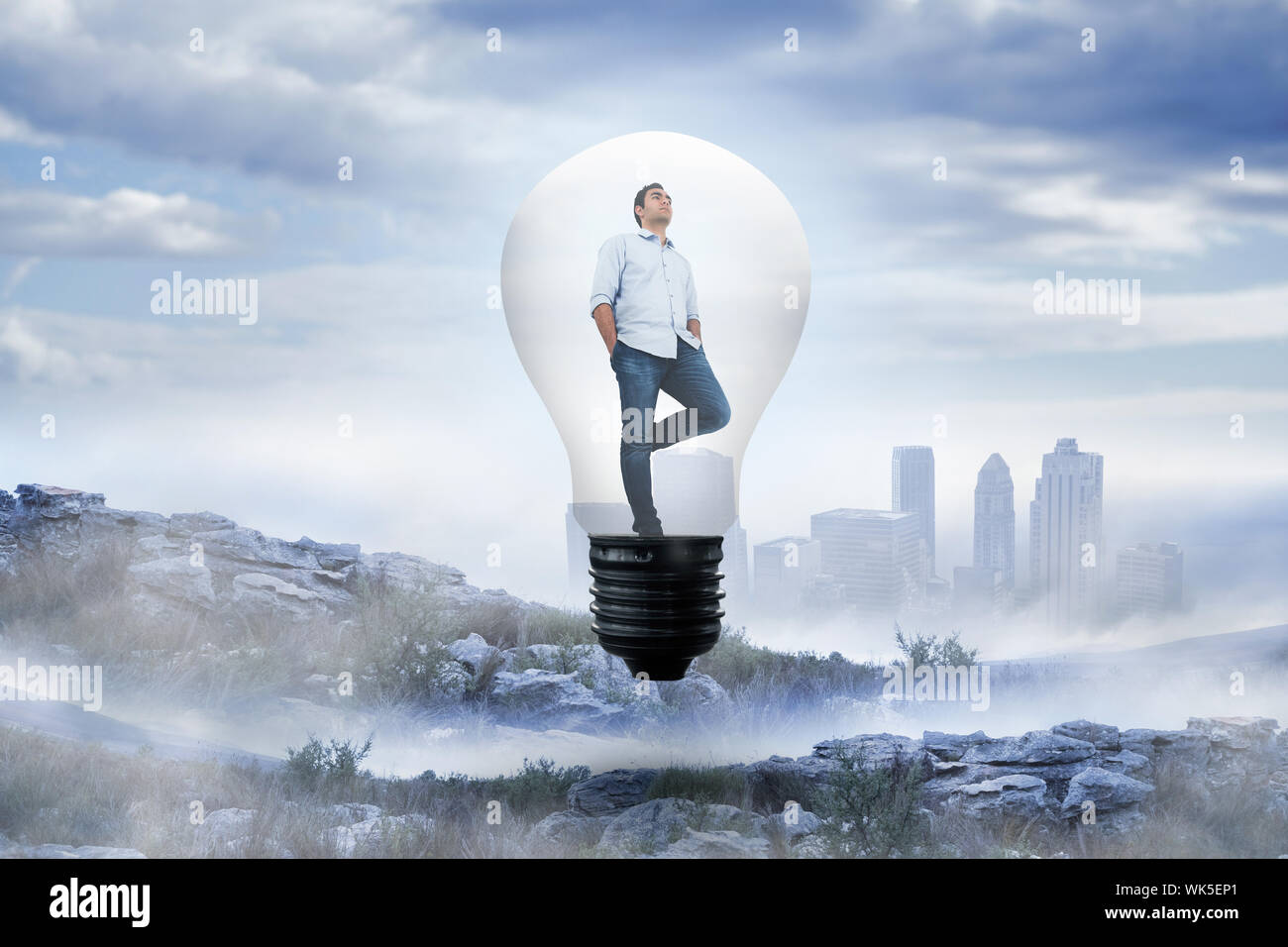 Thinking man in light bulb against rocky landscape Stock Photo - Alamy