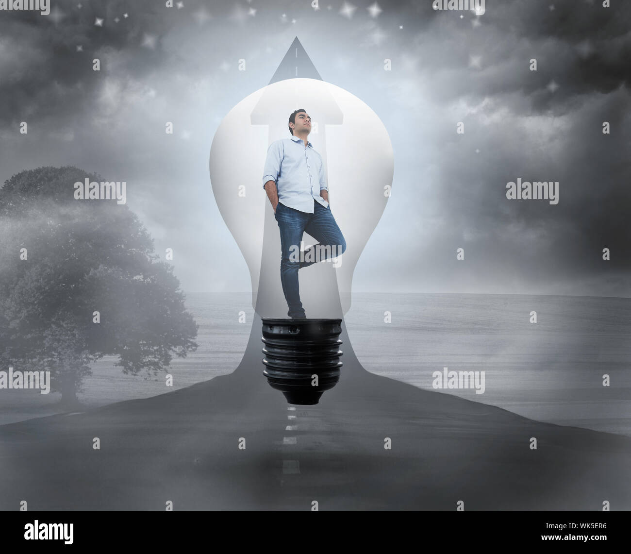 Thinking man in light bulb against road turning into arrow Stock Photo ...