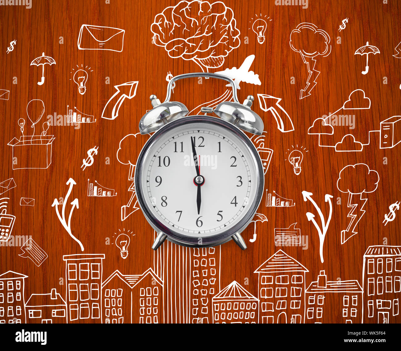 Alarm clock against wooden oak table with doodles Stock Photo - Alamy