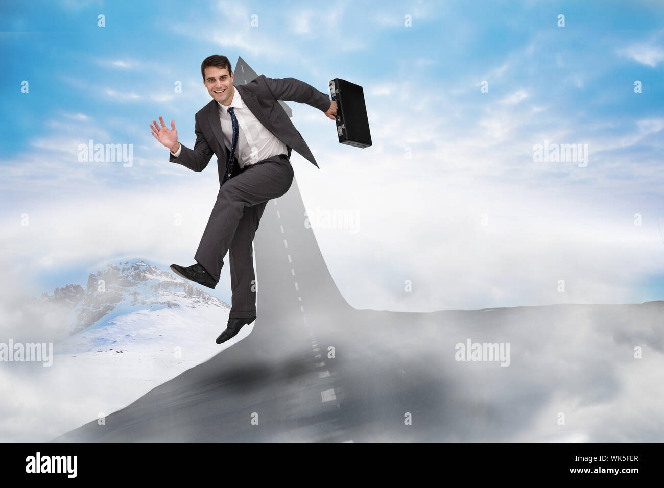 Smiling businessman in a hurry against road turning into arrow Stock ...