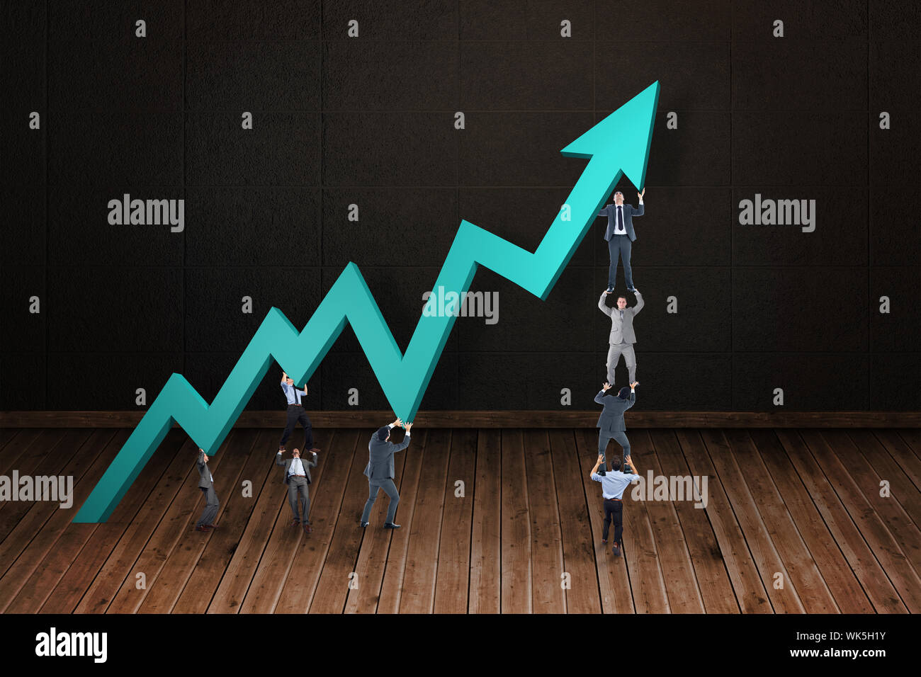 Business teamwork pushing arrow against dark room with floorboards ...