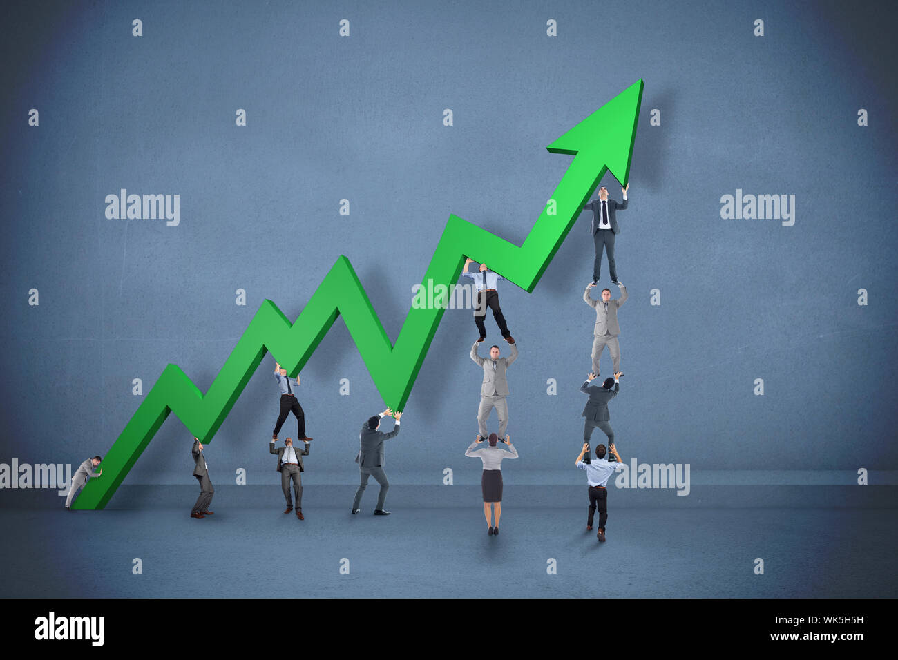 Business teamwork pushing arrow against dark room Stock Photo - Alamy