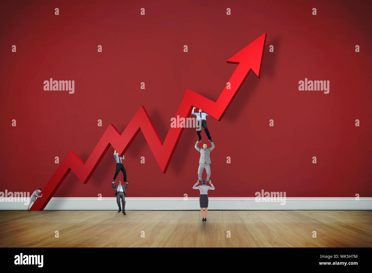 Business teamwork pushing arrow against room with wooden floor Stock ...