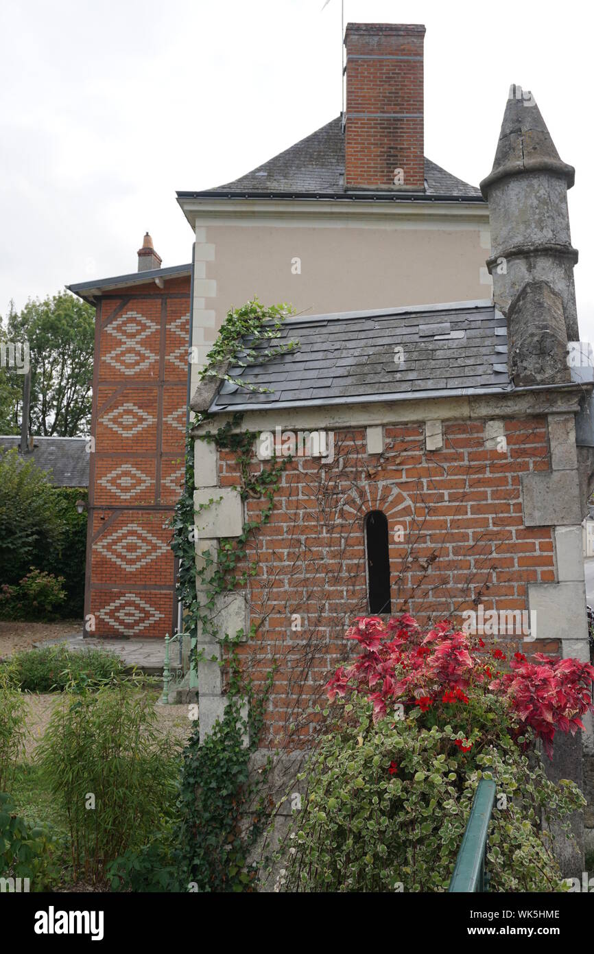 old stone and red brick small building by the river in the country in ...