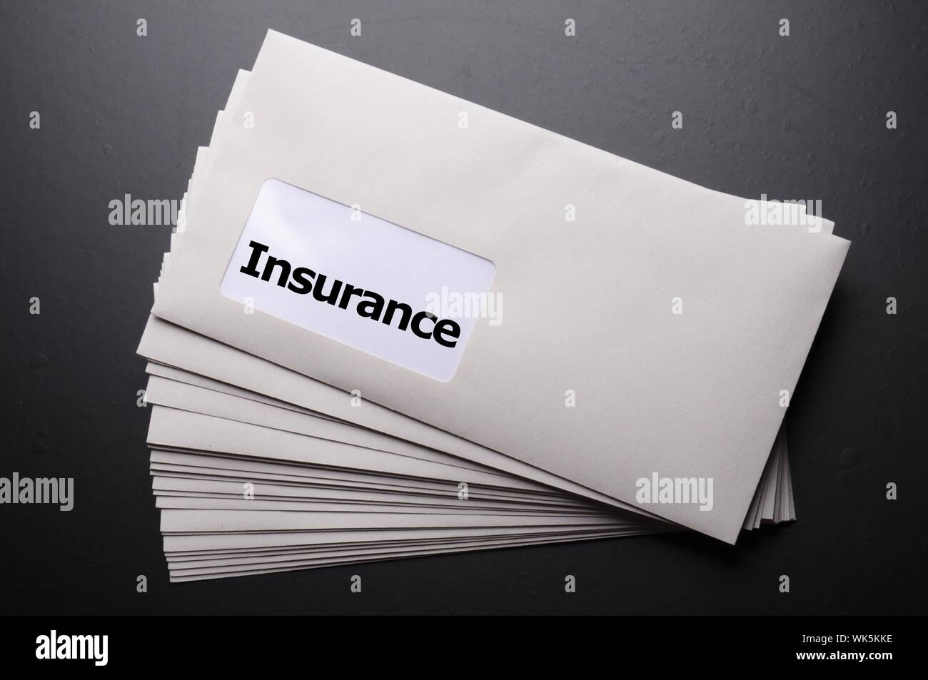 insurance concept with envelope showing risk concept Stock Photo - Alamy