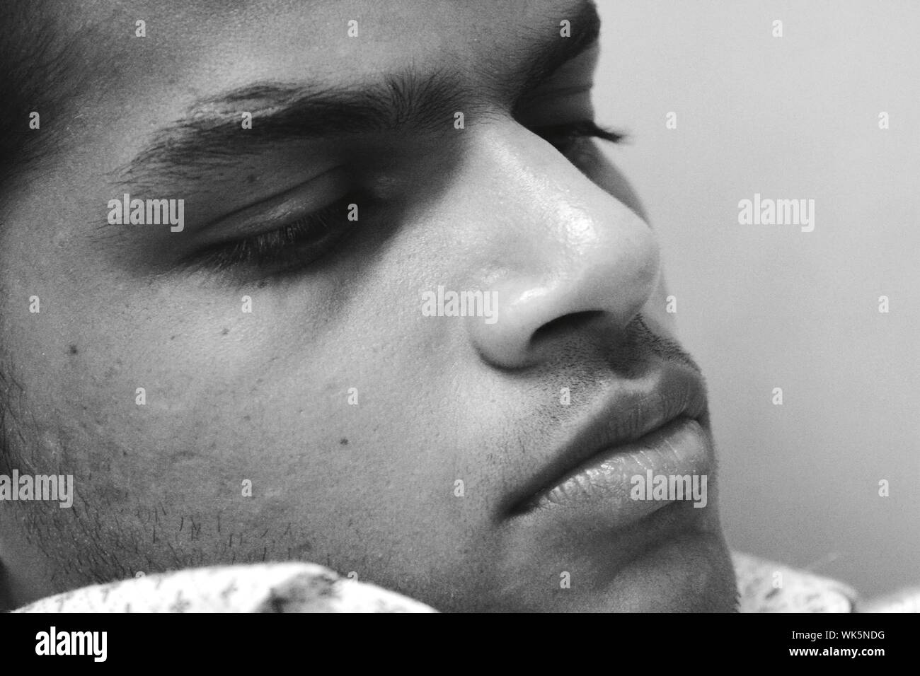Young indian man face looking down hi-res stock photography and images ...