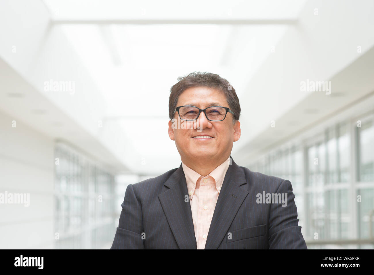 Portrait of 60s Asian Chinese CEO boss smiling. Senior male businessman ...