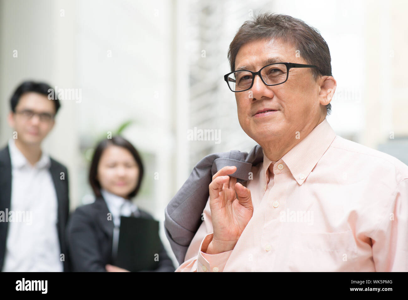 Leader and team member. Portrait of 60s Asian Chinese CEO boss smiling ...