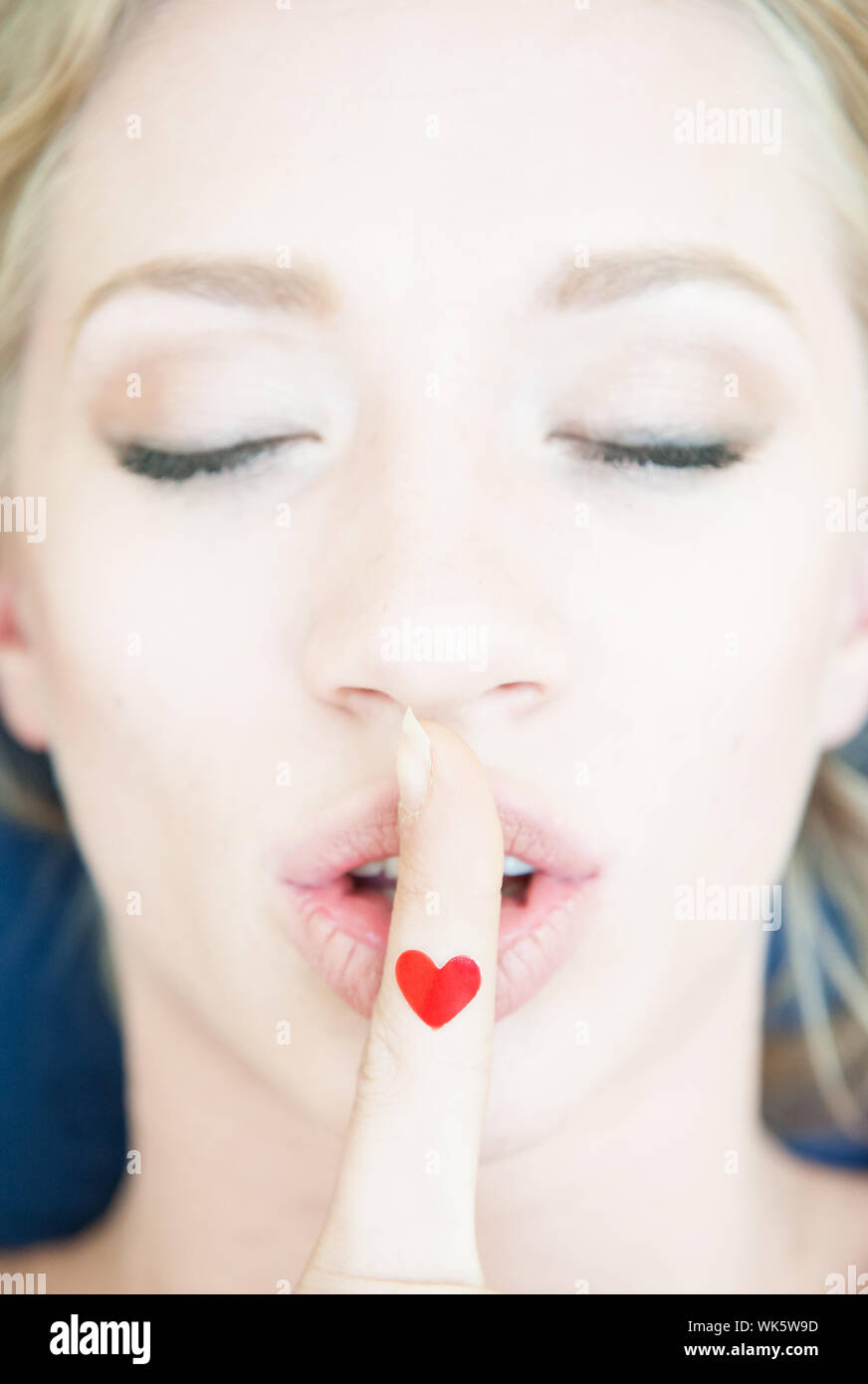 Finger at lips hi-res stock photography and images - Alamy
