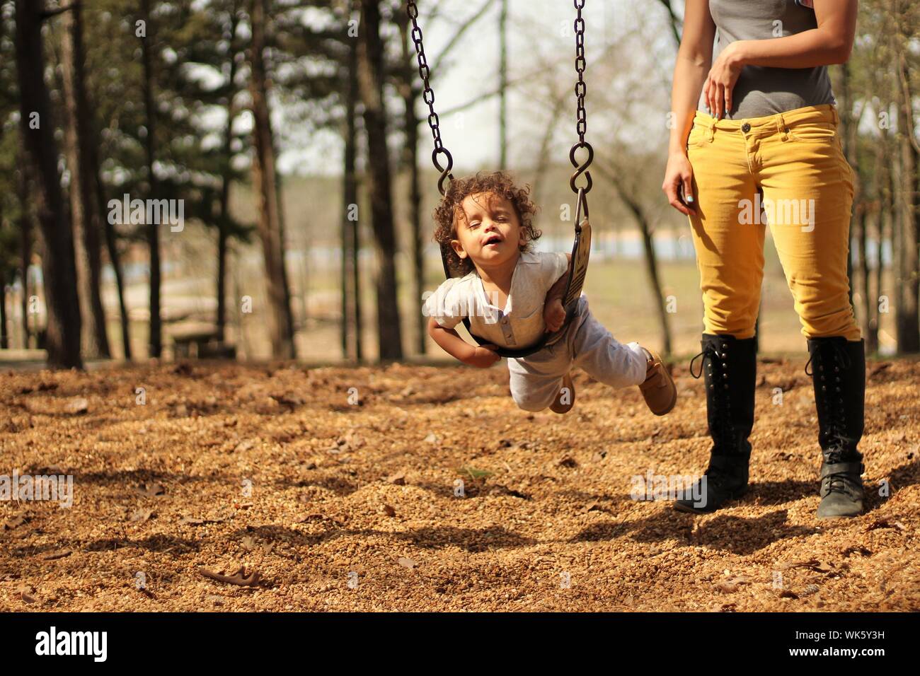 Boy on swing hi-res stock photography and images - Alamy