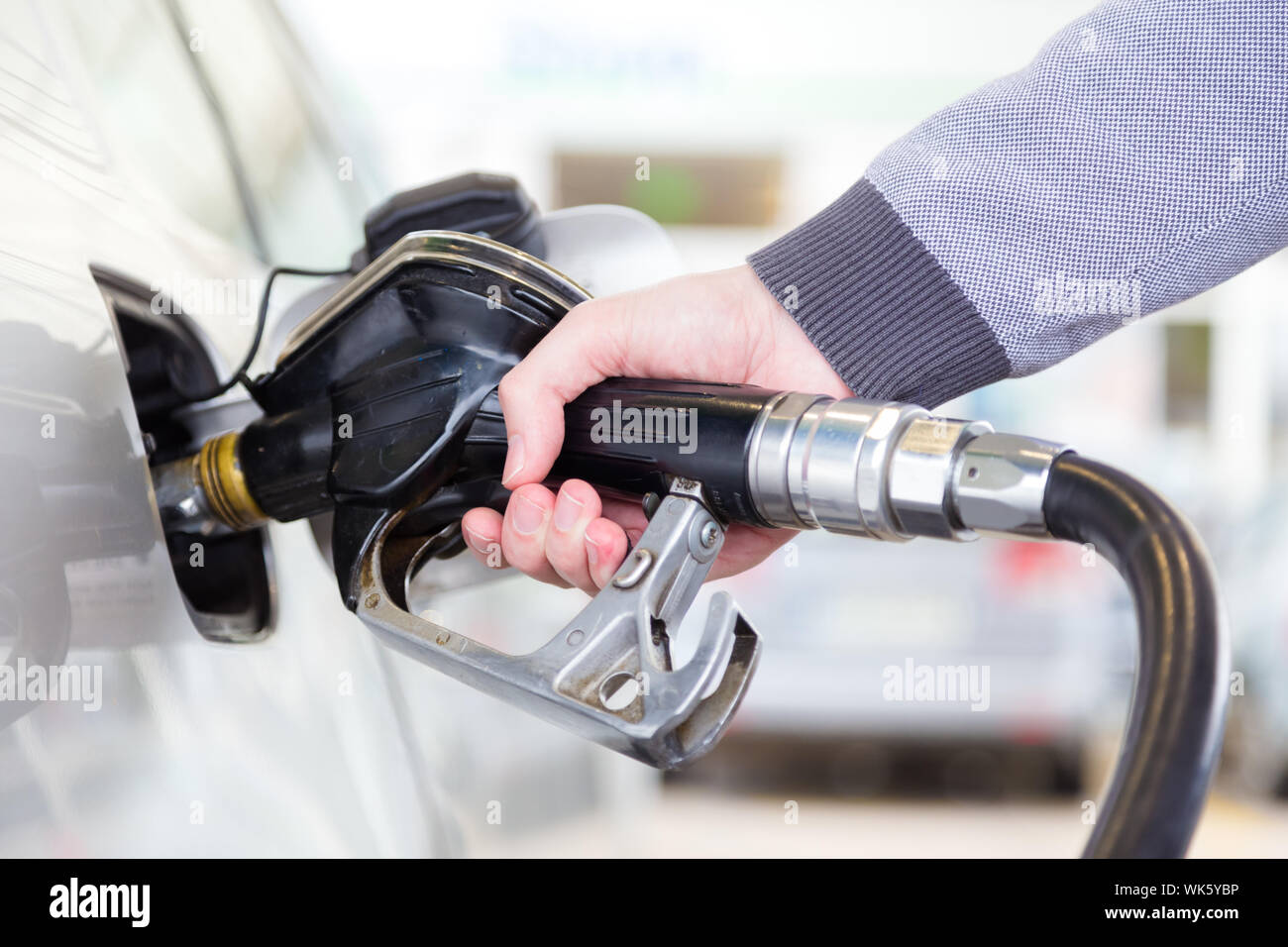 Petrol or gasoline being pumped into a motor vehicle car. Closeup of ...