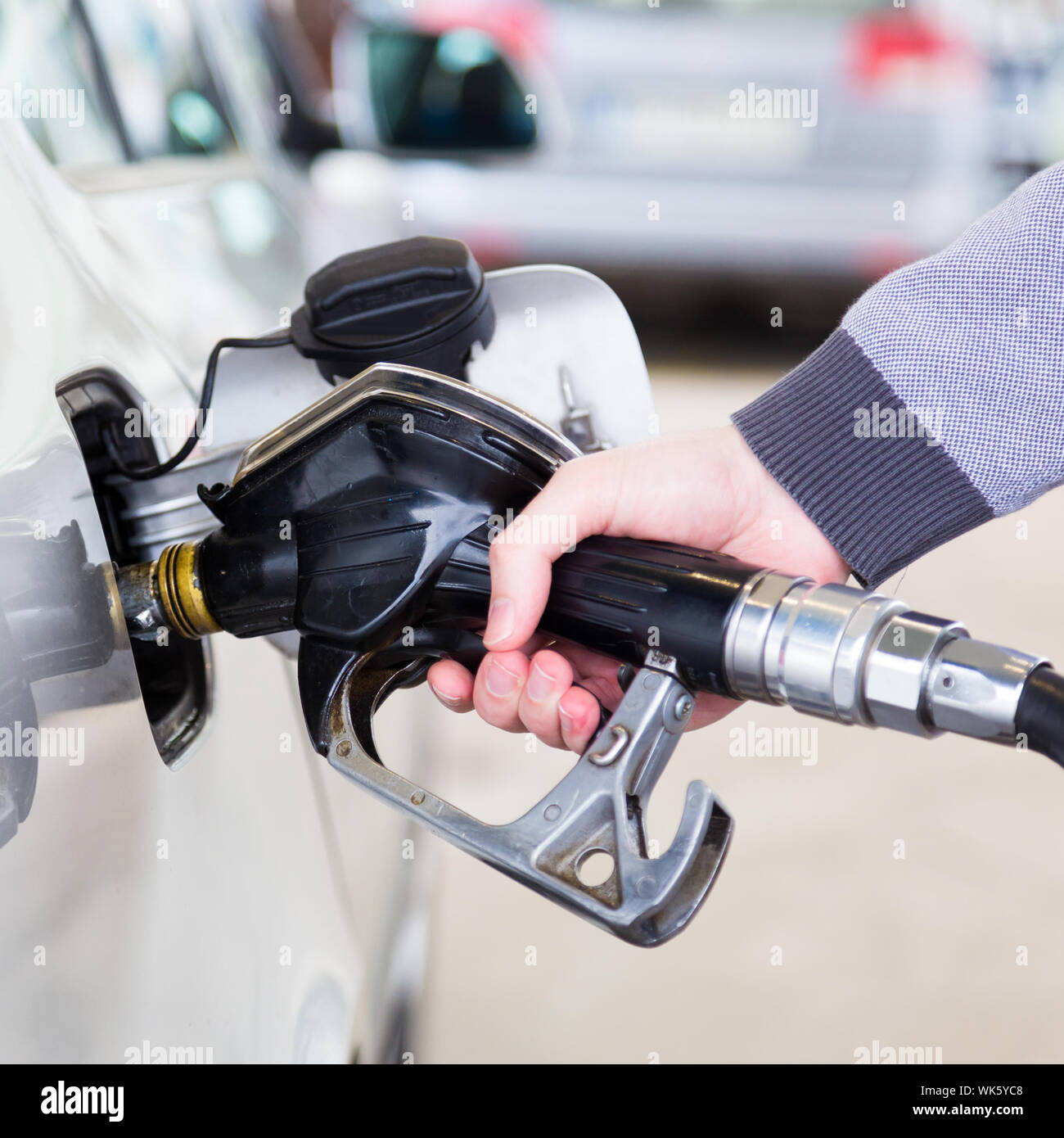 Petrol or gasoline being pumped into a motor vehicle car. Closeup of ...