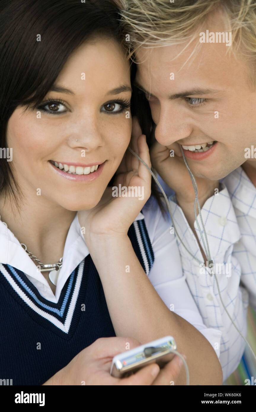 Couple Listening to MP3 Player Stock Photo - Alamy