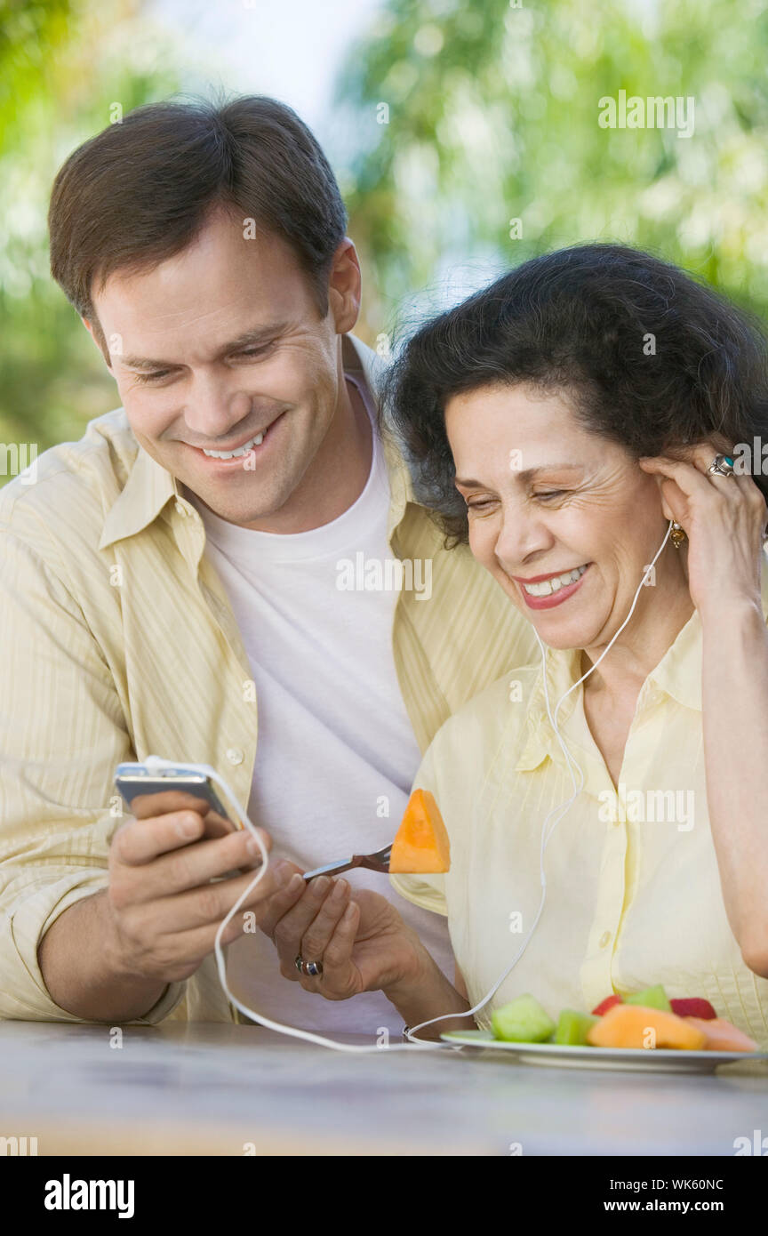 Son Showing Mother How to Use iPod Stock Photo - Alamy