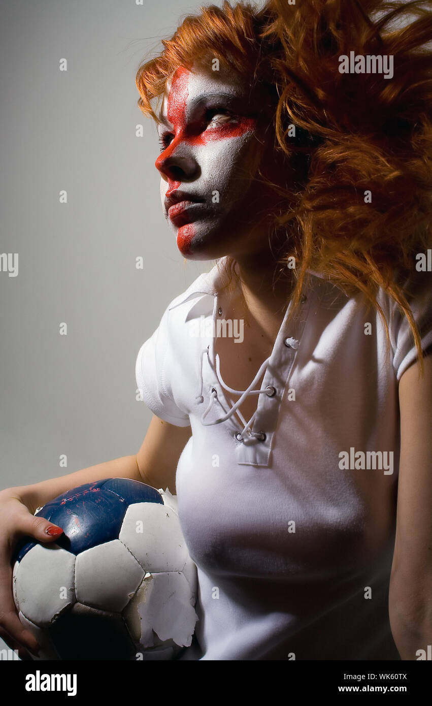 english football makeup girl holding worn soccer ball, looking forward ...