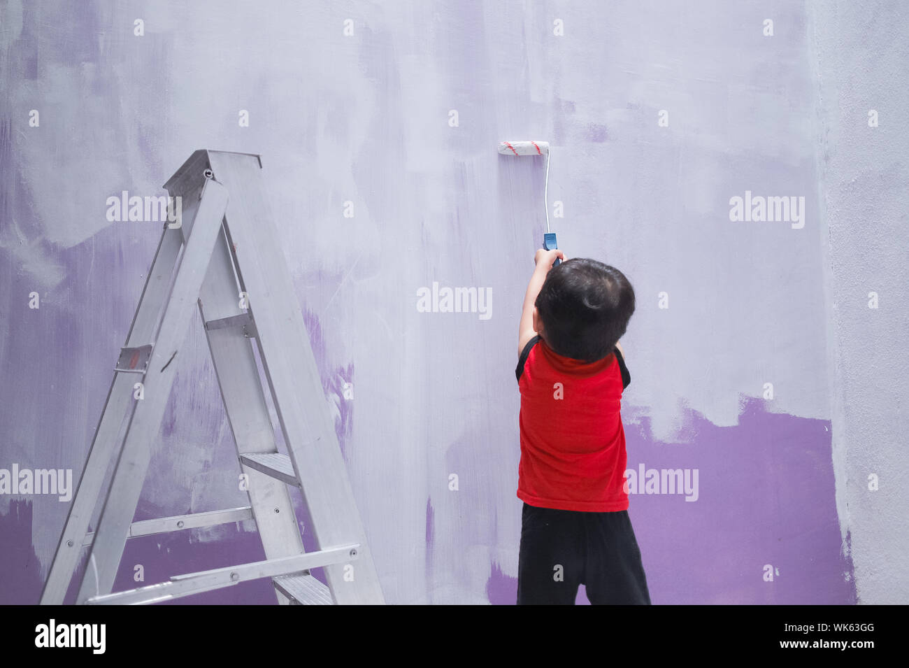 Rear View Of Boy Painting Wall Stock Photo - Alamy