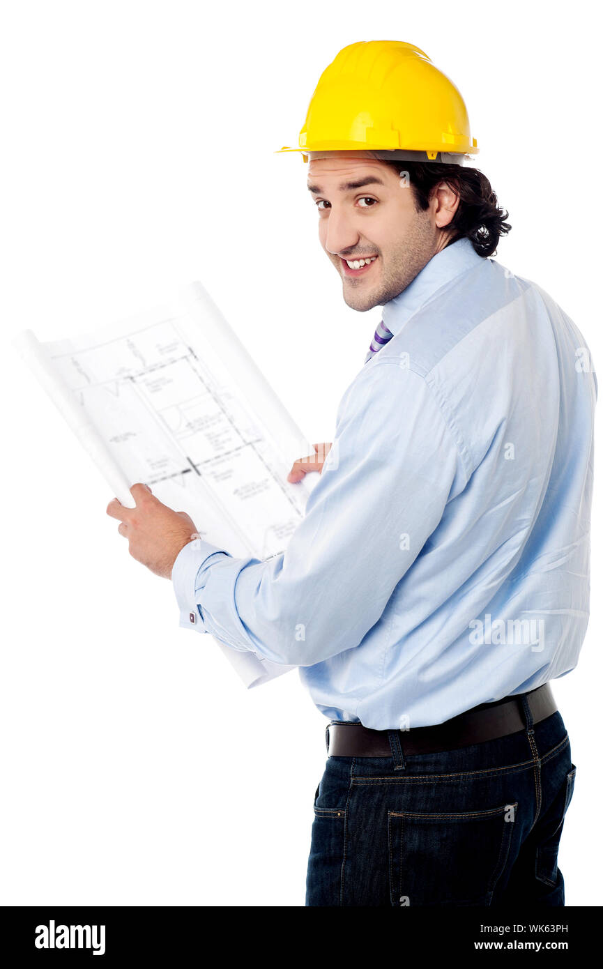 Construction worker turn around with blueprint Stock Photo - Alamy