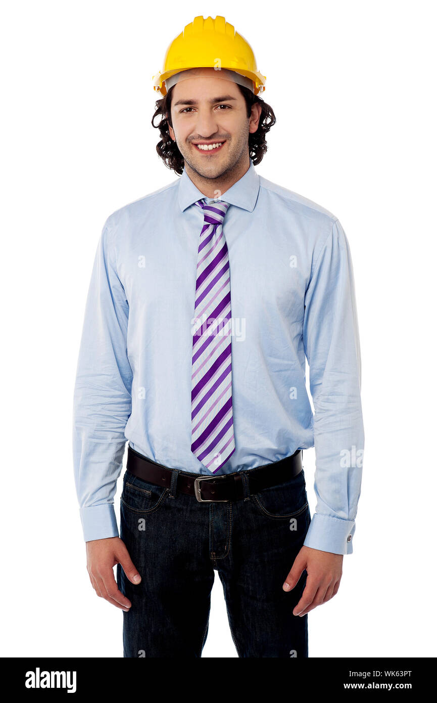 Engineer with yellow hard hat posing casually Stock Photo - Alamy