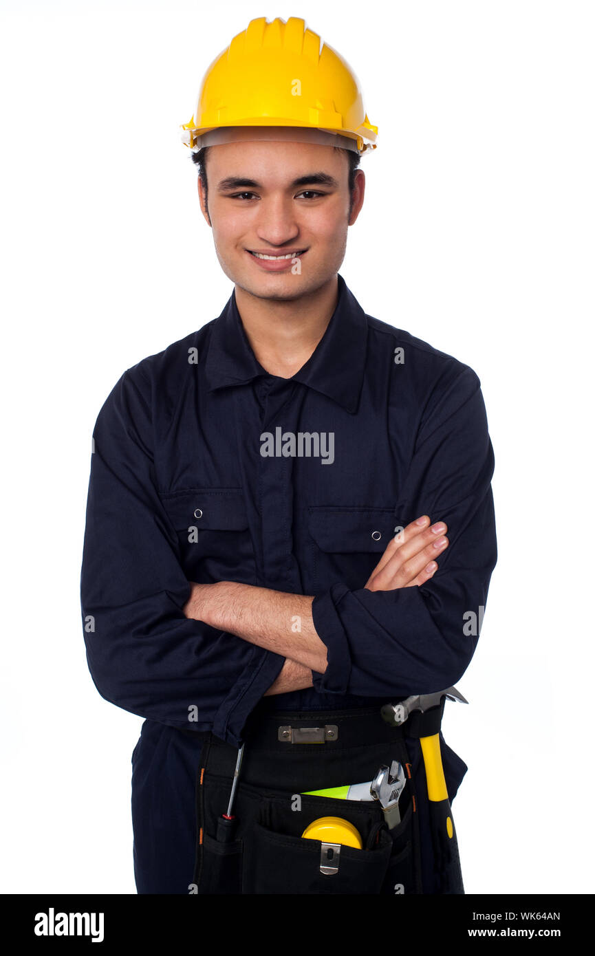 Smiling young male contractor with arms crossed Stock Photo - Alamy