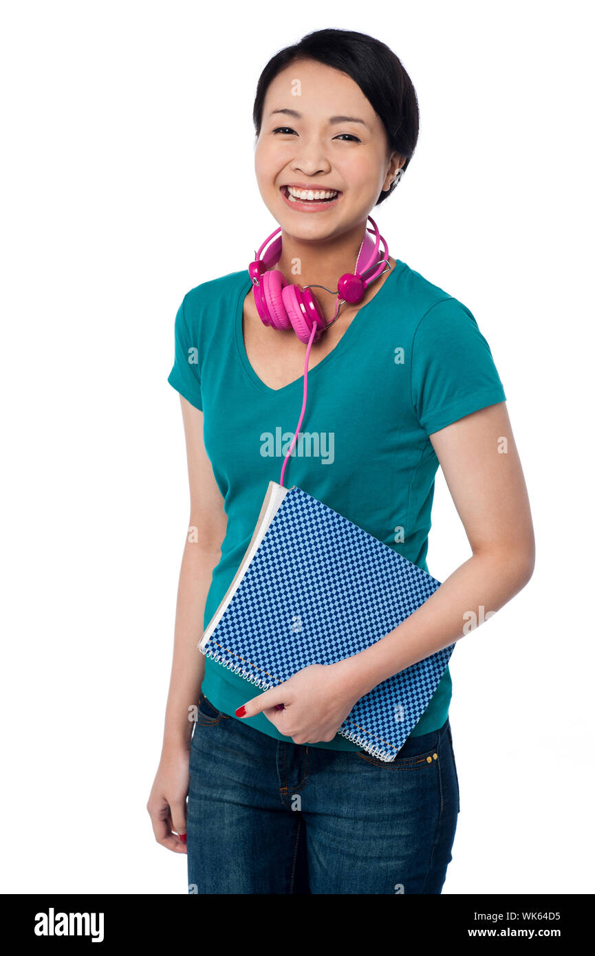 Beautiful girl holding notebook headphone around her neck Stock Photo ...