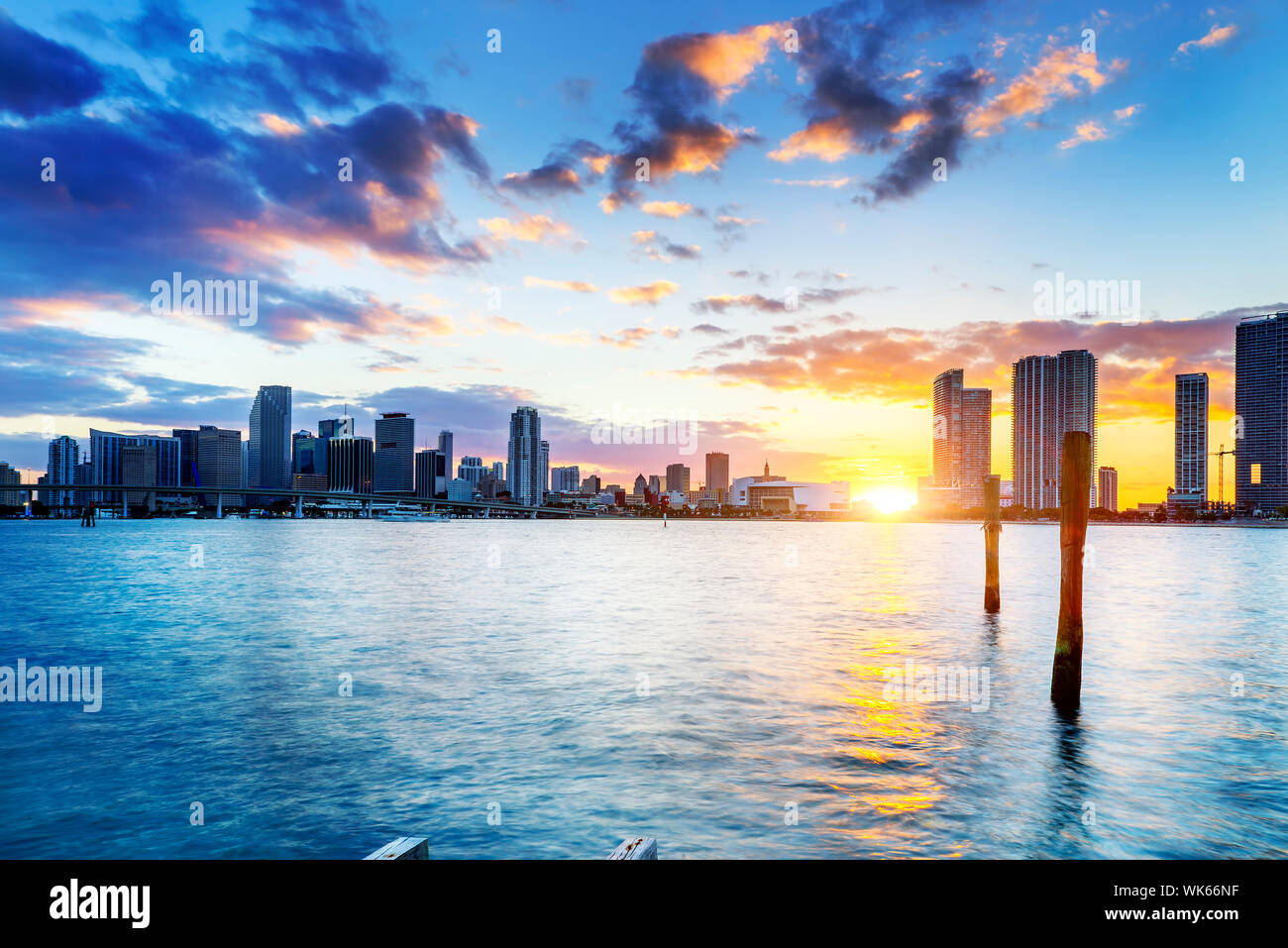 Miami city skyline panorama at dusk with urban skyscrapers over sea ...