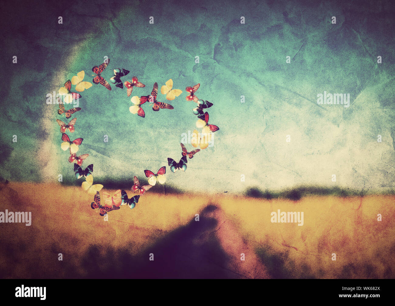 Heart shape made of colorful butterflies on vintage field background ...