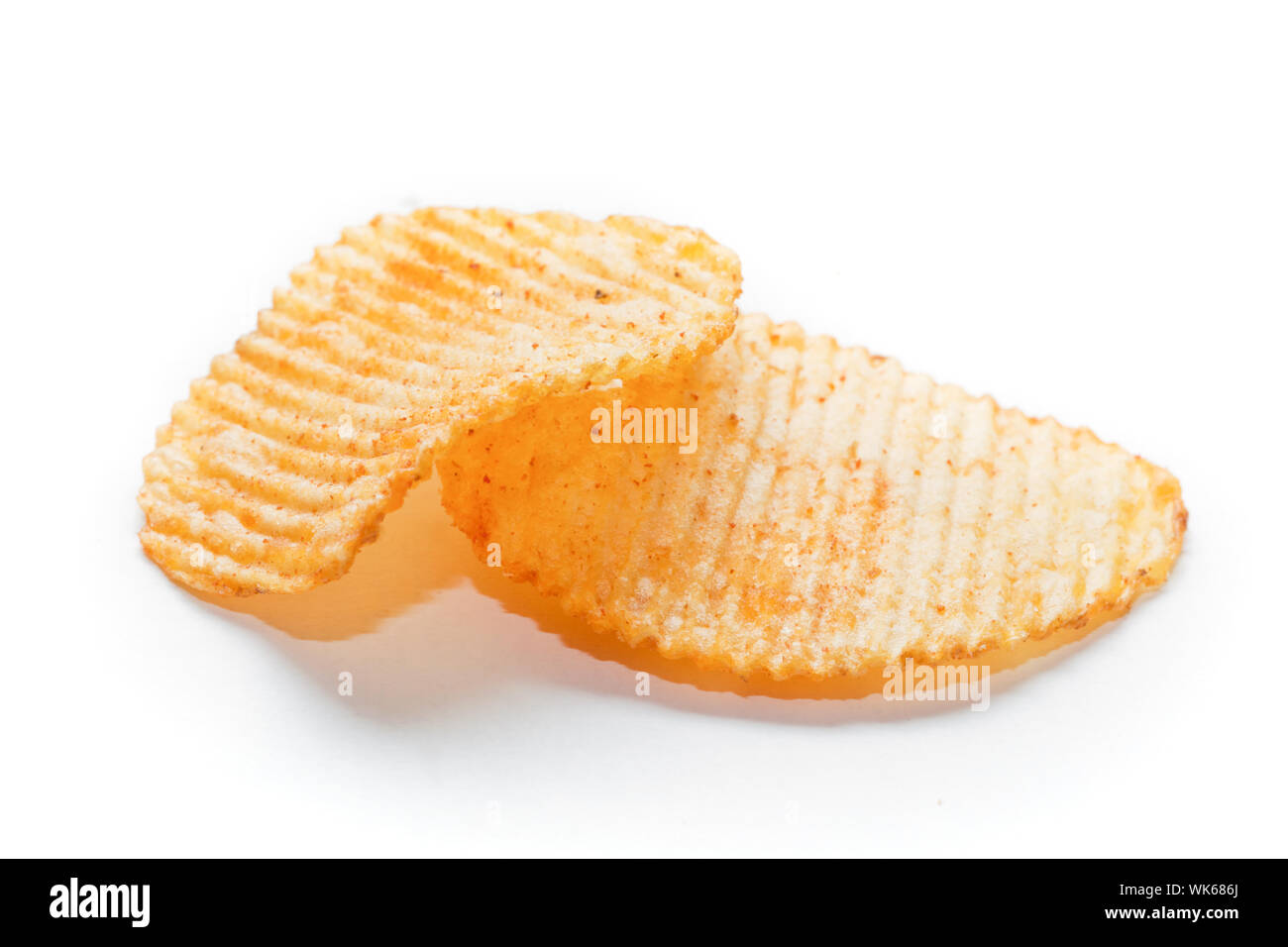 Two spiced potato chips isolated on white background Stock Photo - Alamy