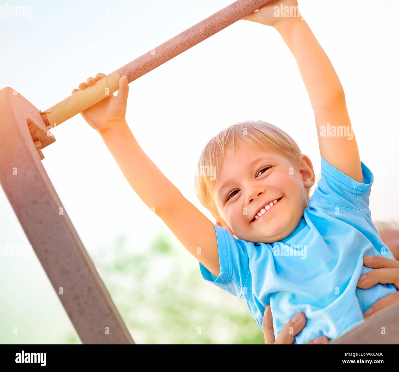 Little boy with fathers help catch up on the horizontal bar, active ...