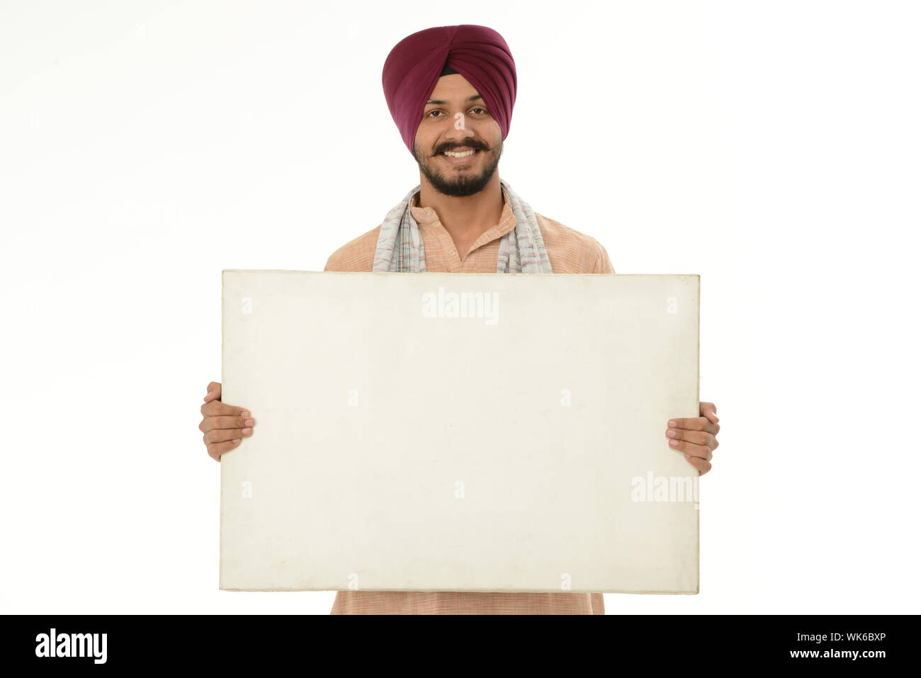 Rural man smiling and showing placard Stock Photo - Alamy