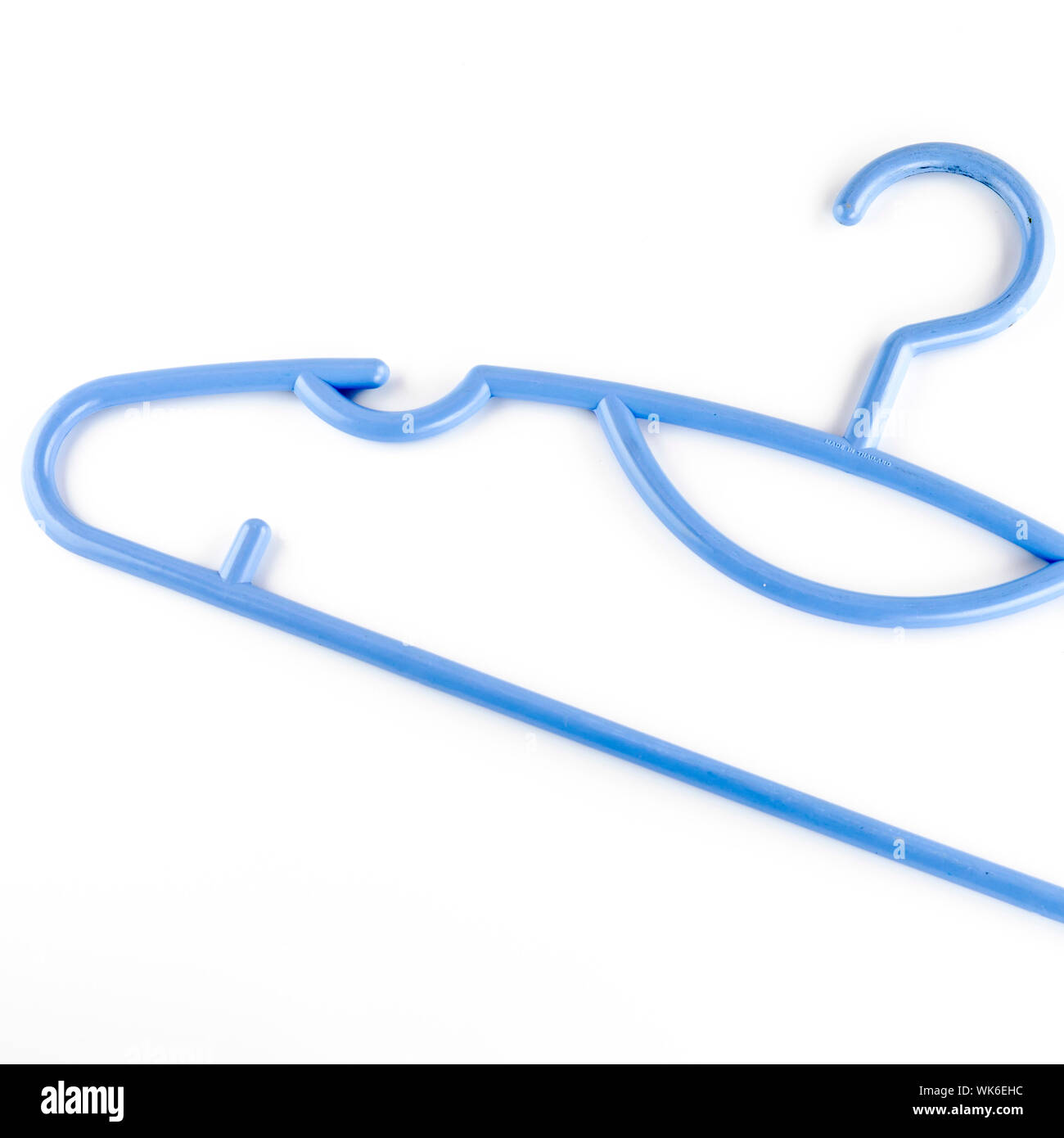 blue plastic clothes hanger on a white background Stock Photo - Alamy