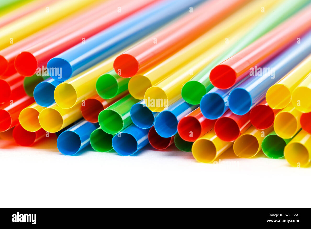 Colored Plastic Drinking Straws on a white background Stock Photo - Alamy