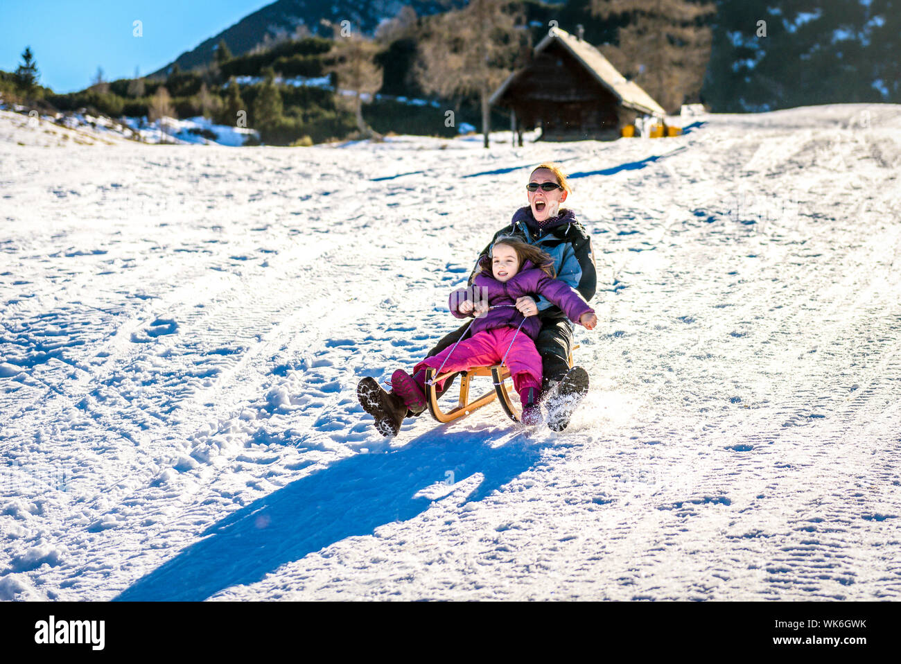 Child sliding on snow hi-res stock photography and images - Alamy