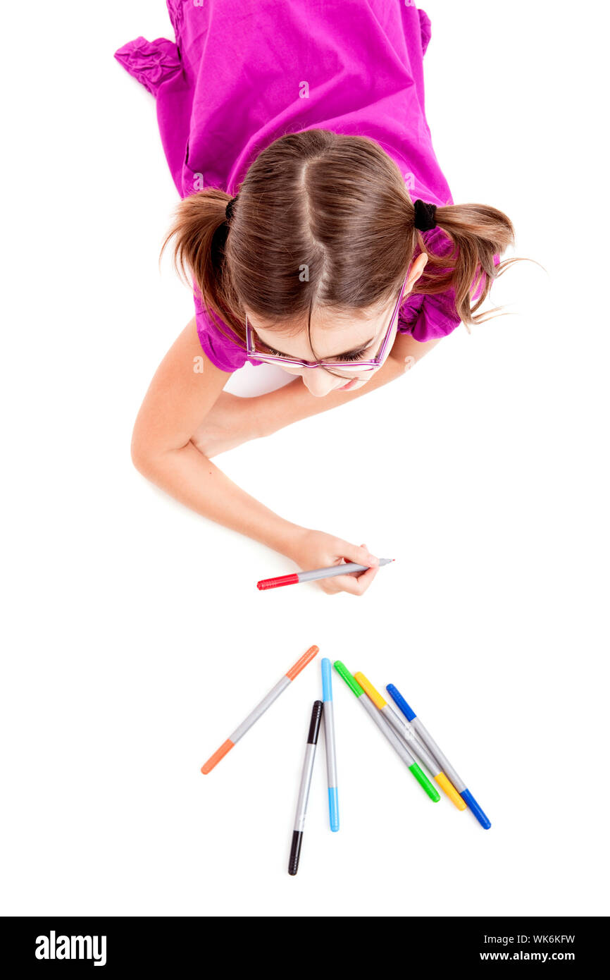 Girl lying on floor and making drawings on paper Stock Photo - Alamy