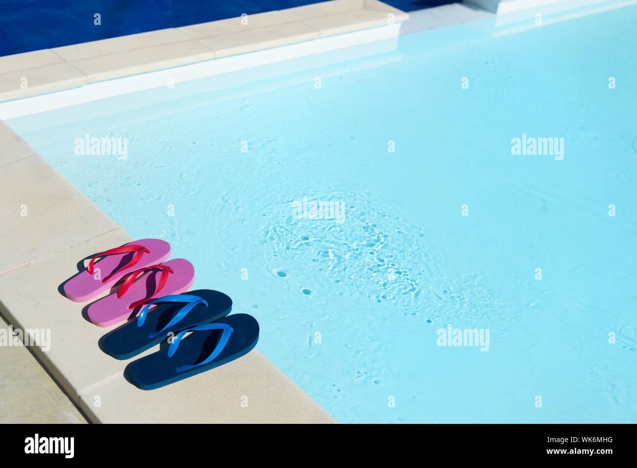 Flip flops for him and her at the swimming pool Stock Photo - Alamy