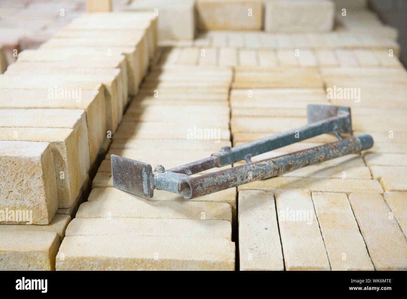 Stone bricks and scaffolding to build a house or wall Stock Photo - Alamy