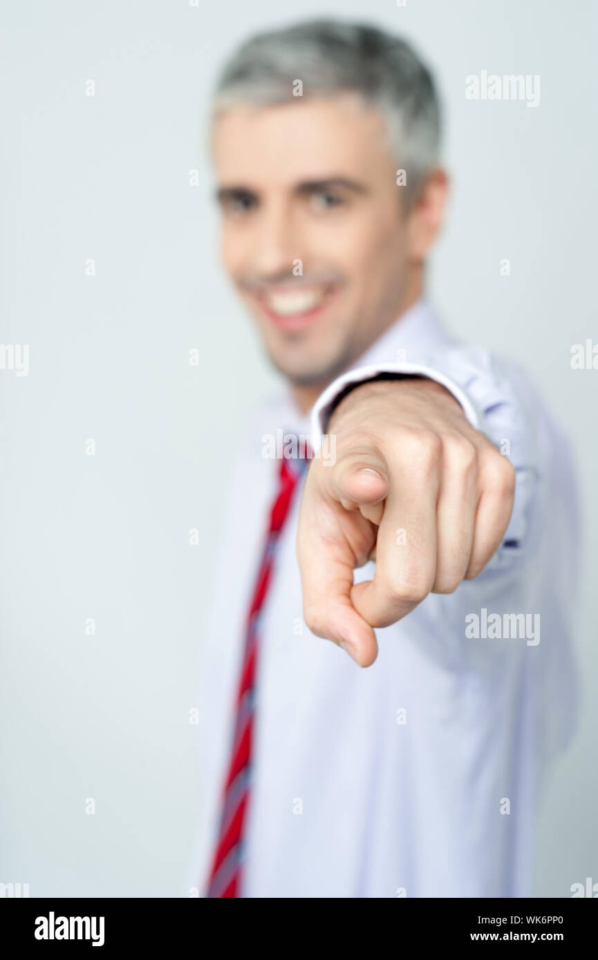 Young businessman pointing finger at viewer Stock Photo - Alamy