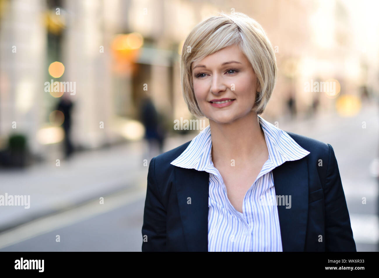Happy female executive posing at outdoors Stock Photo - Alamy
