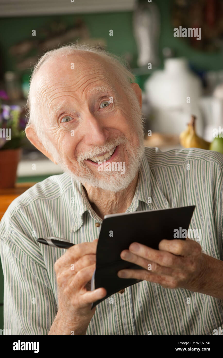 Senior man at home with checkbook Stock Photo - Alamy