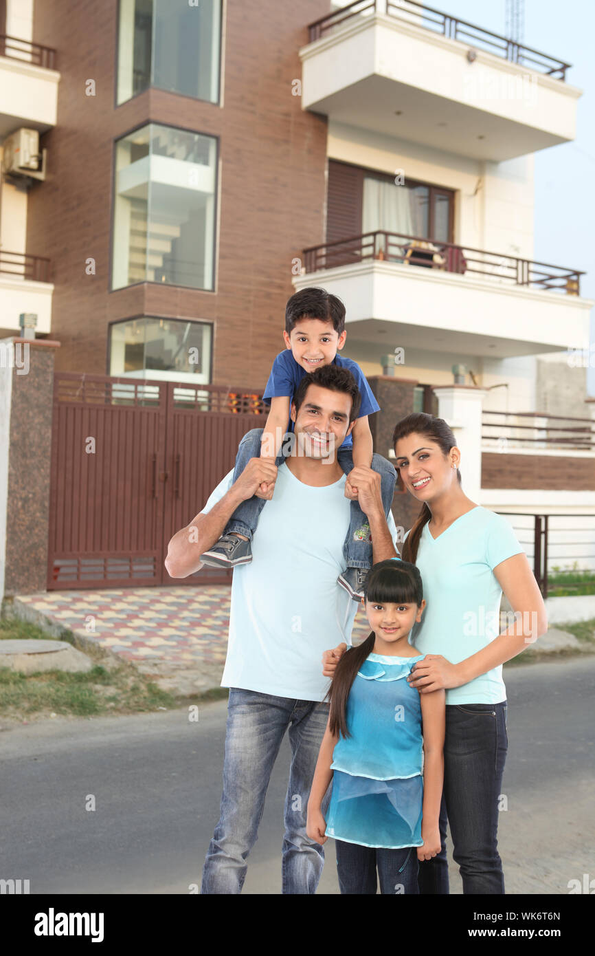 Family standing in front of house hi-res stock photography and images ...