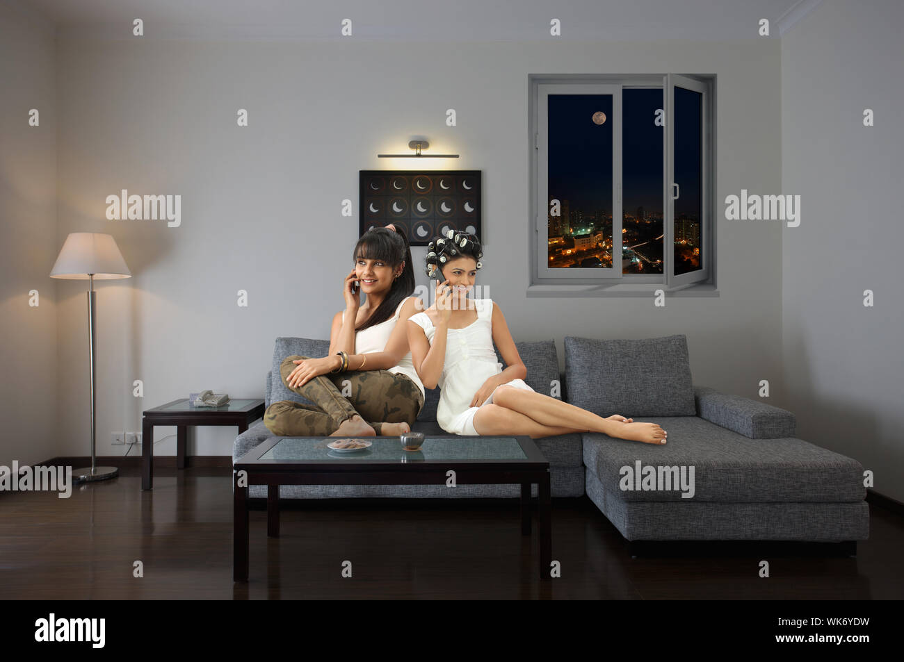 Two friends sitting back back hi-res stock photography and images - Alamy