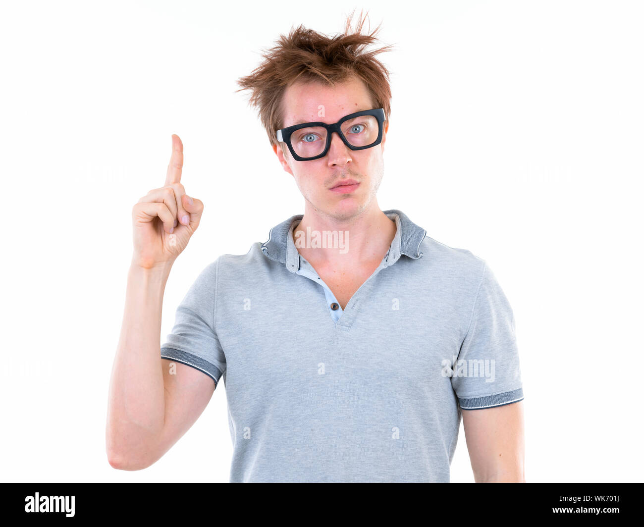 Funny young nerd man with big eyeglasses pointing up Stock Photo - Alamy