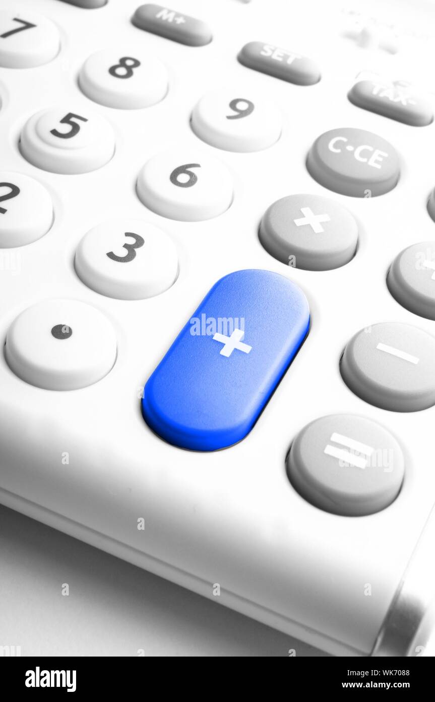 adding up figures concept with modern white calculator in office Stock ...