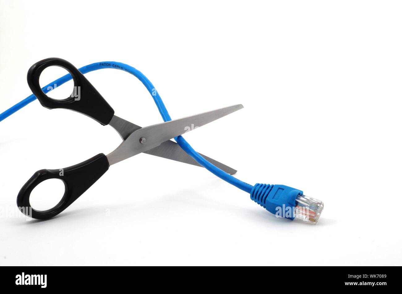 internet addiction concept with scissors and blue network cable on ...